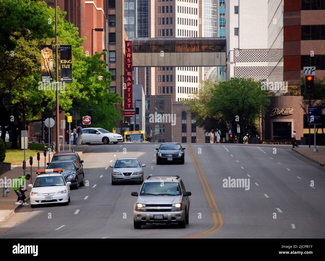 Traffic driving down a street in downtown Dallas Texas in front of ...