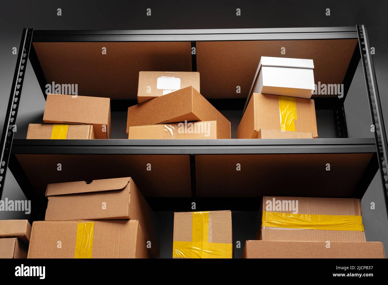 Rows of shelves with cardboard boxes in modern warehouse Stock Photo ...