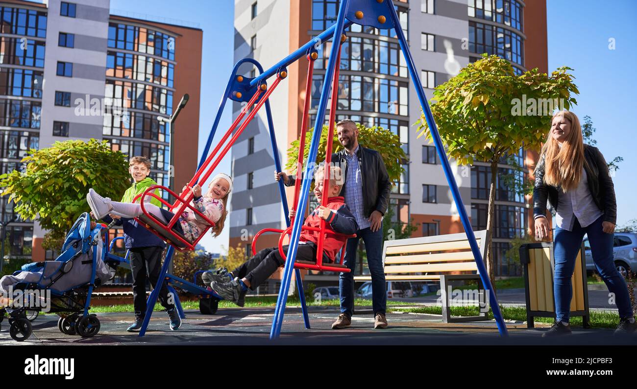 Happy family - father, mother and children having fun together on ...