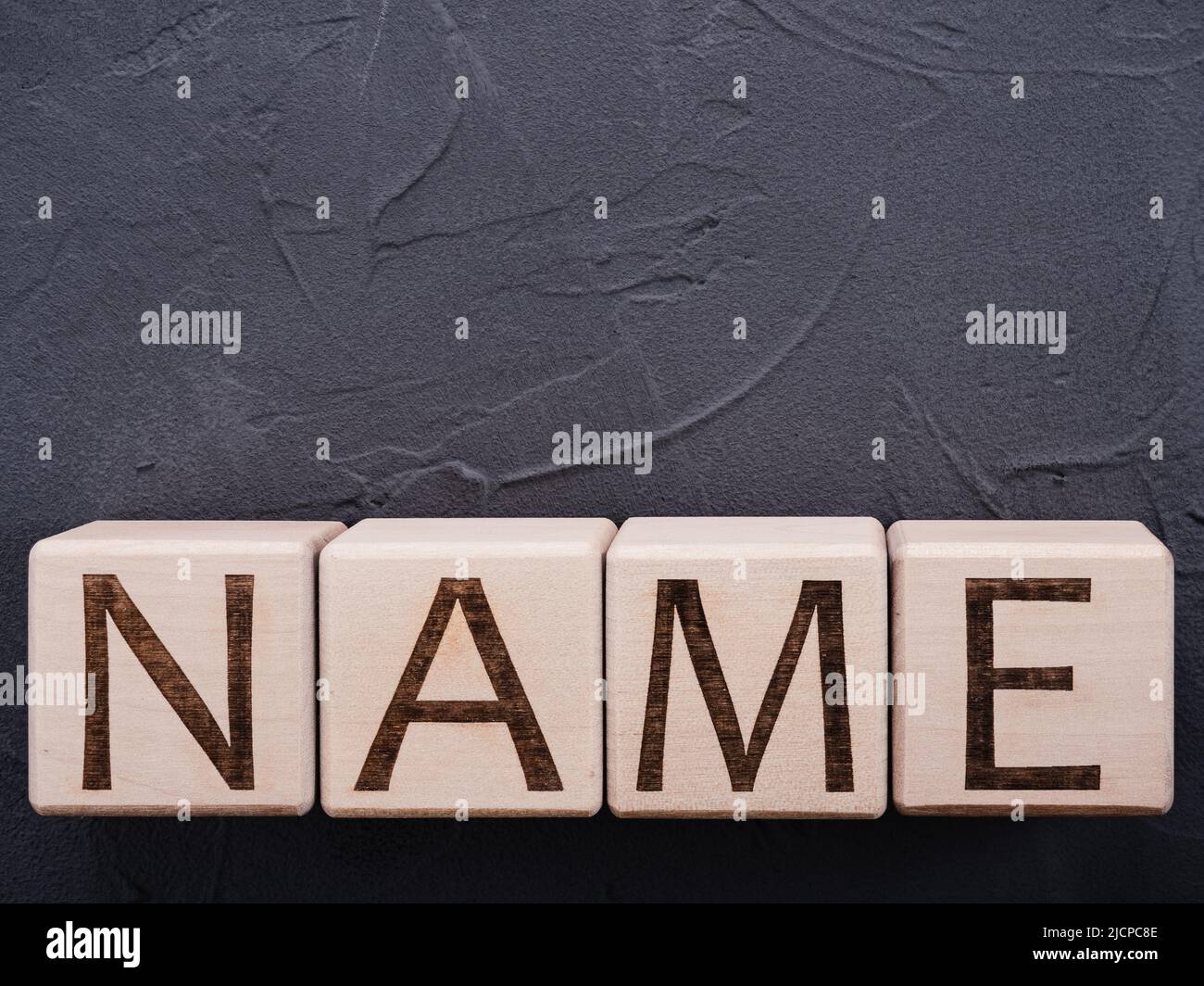 Word NAME on wooden blocks on grey concrete background Stock Photo - Alamy