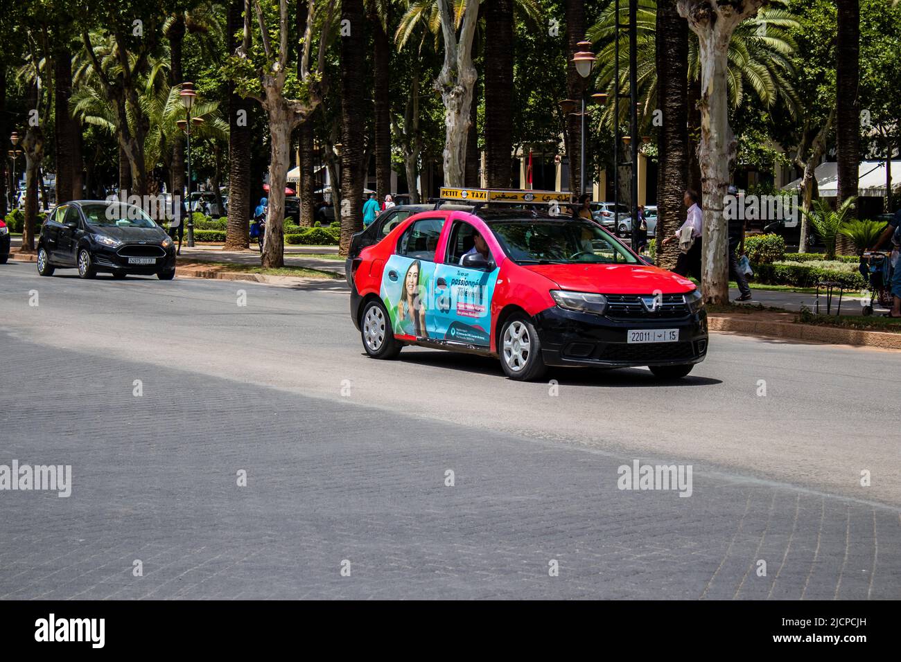 Fez, Morocco - June 14, 2022 Taxi driving through the streets of Fez ...