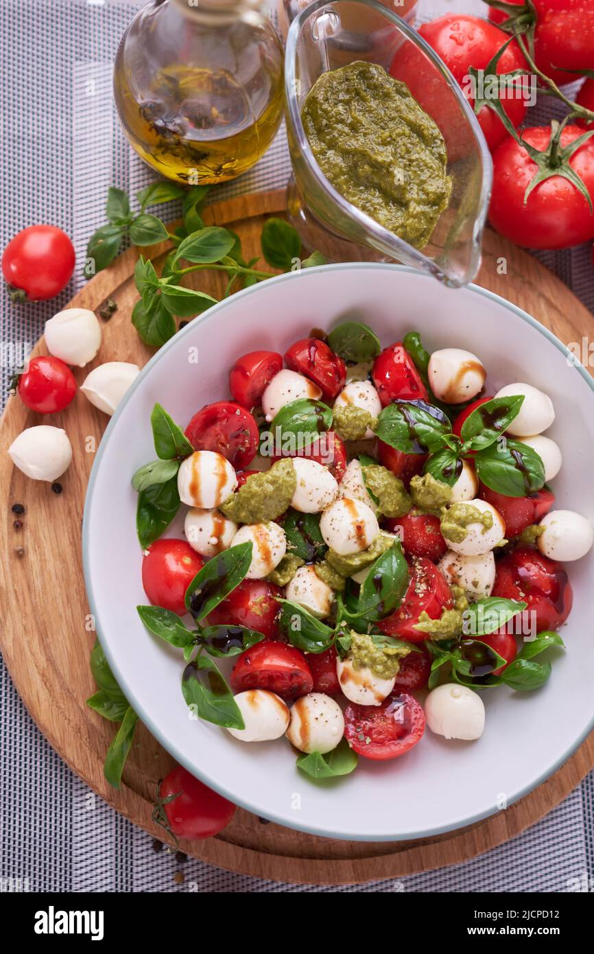 Caprese salad - Mini mozzarella cheese in glass bowl, tomato and basil ...