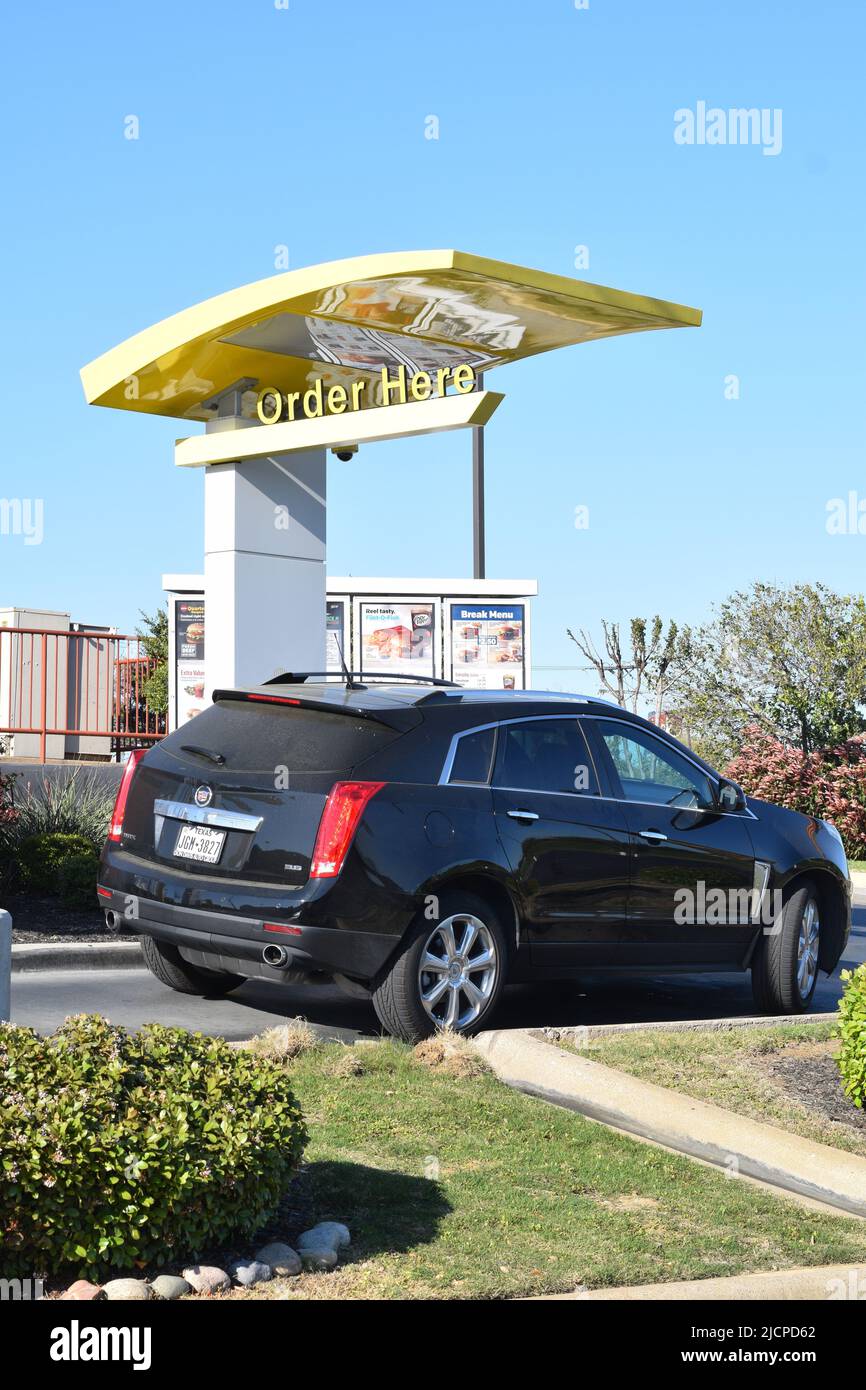 Black Cadillac SUV in a McDonald's drive thru Stock Photo - Alamy