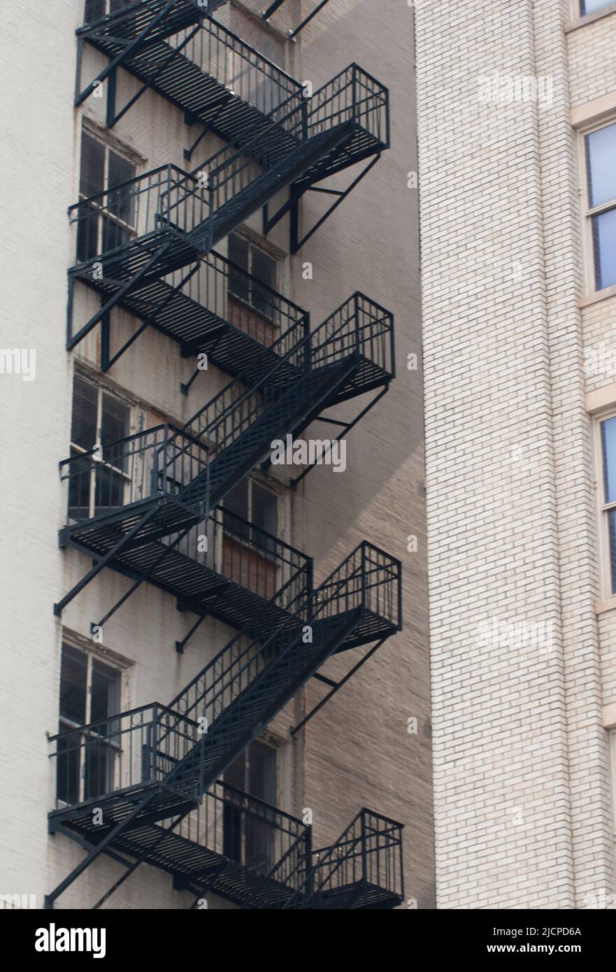 Black metal fire escape on the side of a tall skyscraper in an American ...