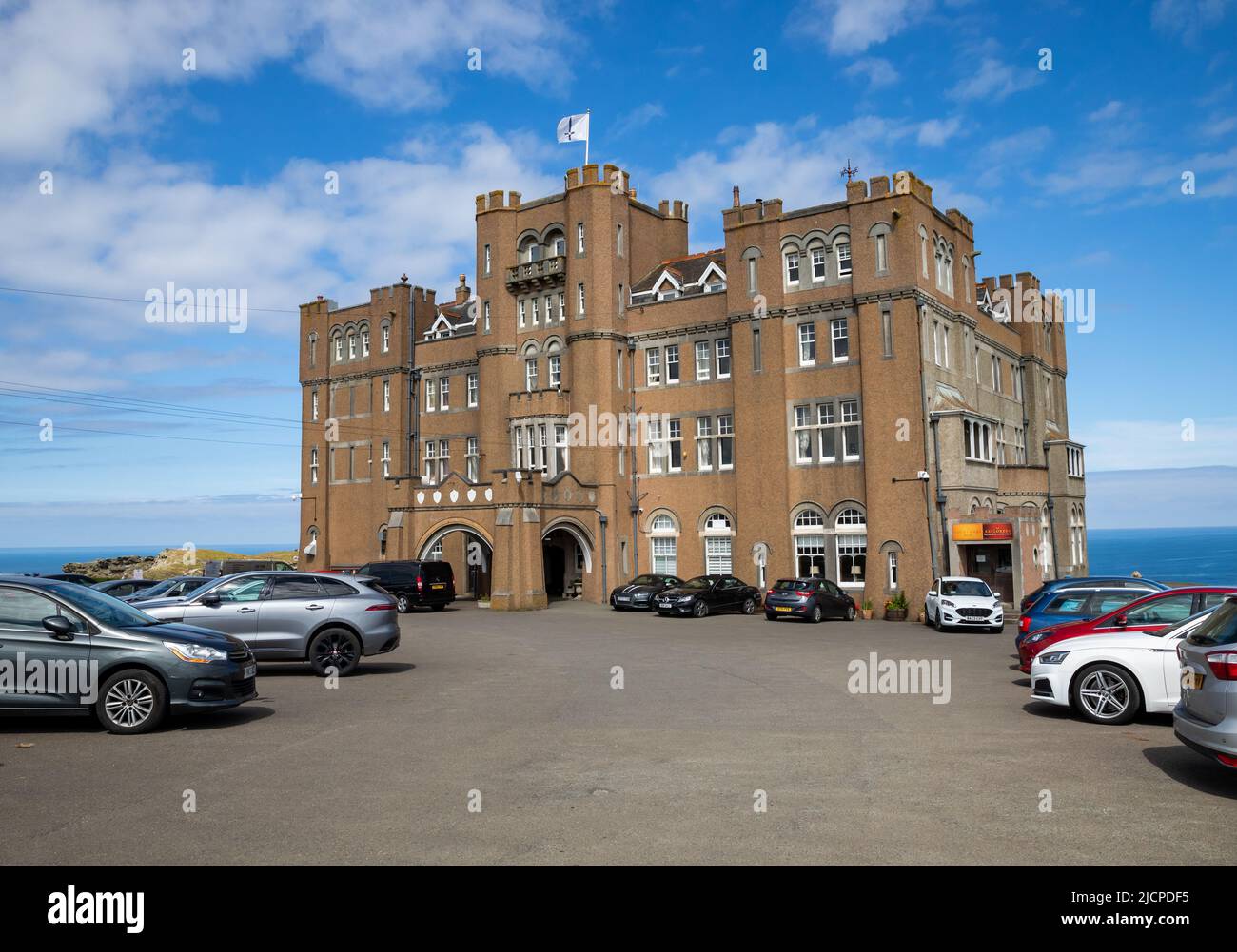 Blue sky over Camelot Castle Hotel in Tintagel, Cornwall on a Summer's ...