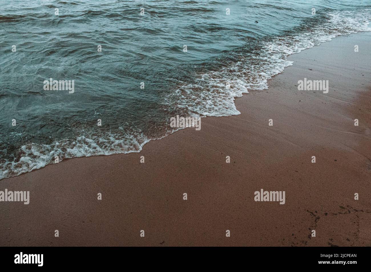 Waves crashing on the beach Stock Photo - Alamy