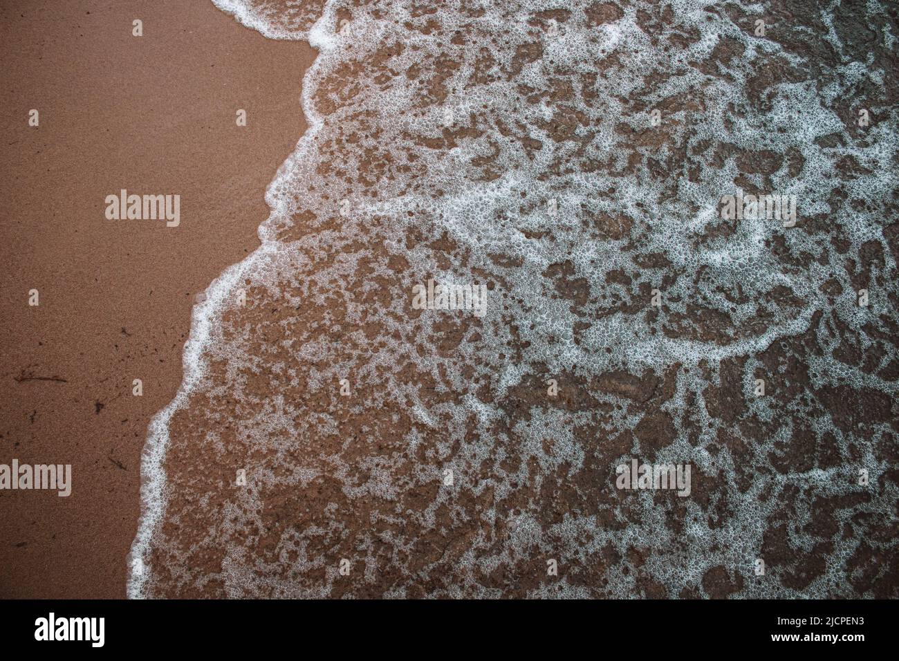 Wave washing onto beach hi-res stock photography and images - Alamy