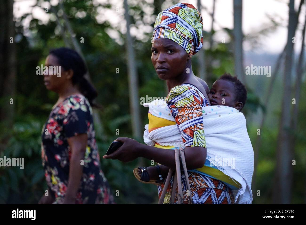 A woman carries her child on a street in Kigali, Rwanda. Picture date ...