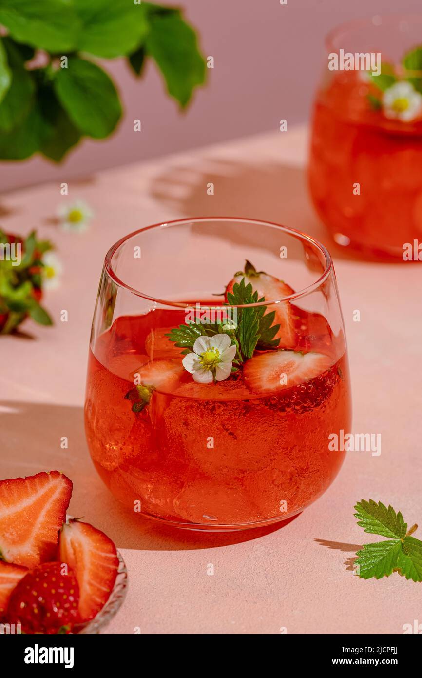 Cold summer drink - strawberry lemonade with strawberry flowers and ice ...