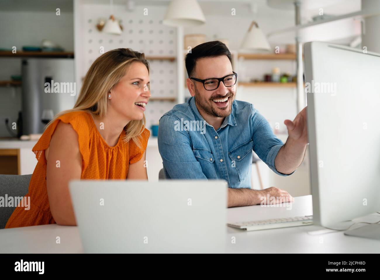 Happy couple doing business together working at small office Stock ...