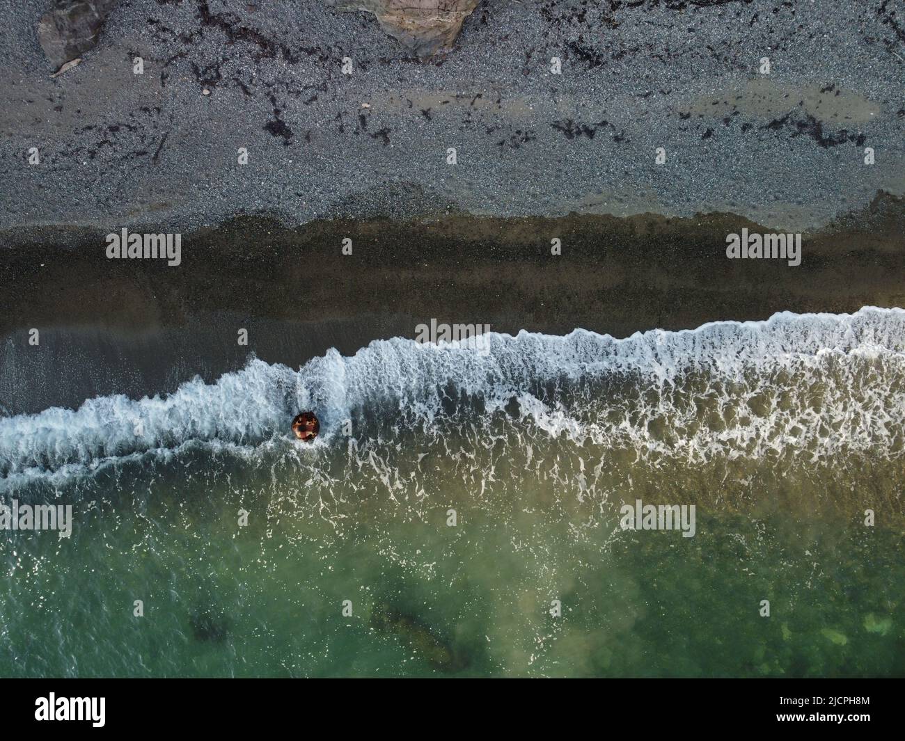 Aerial view from above on calm azure sea and volcanic rocky shores ...