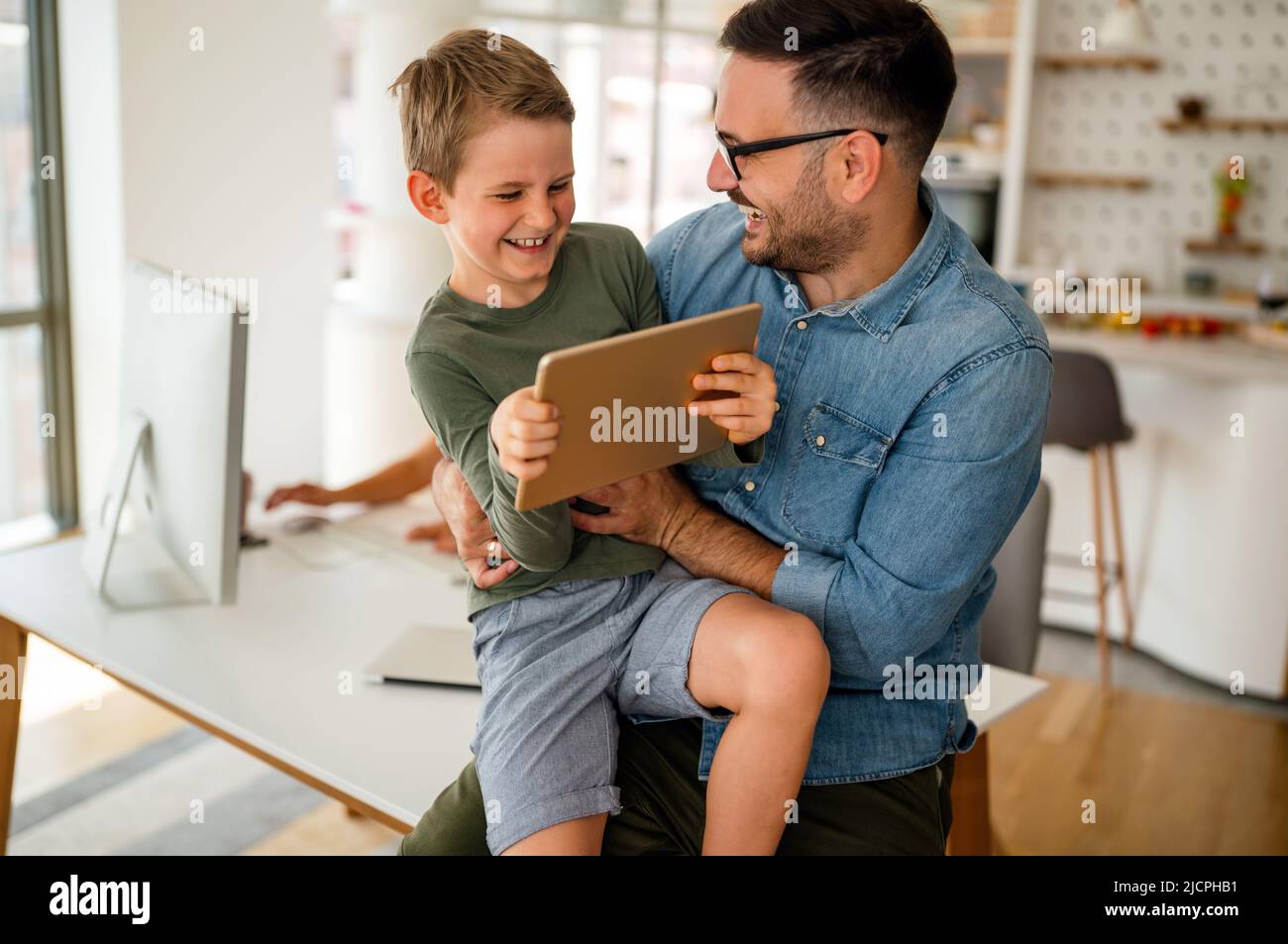 Father and child using digital tablet for e-learning. Education home ...