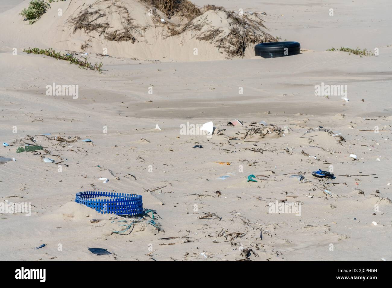 Debris and trash left by people or washed up on the beach from boats at ...