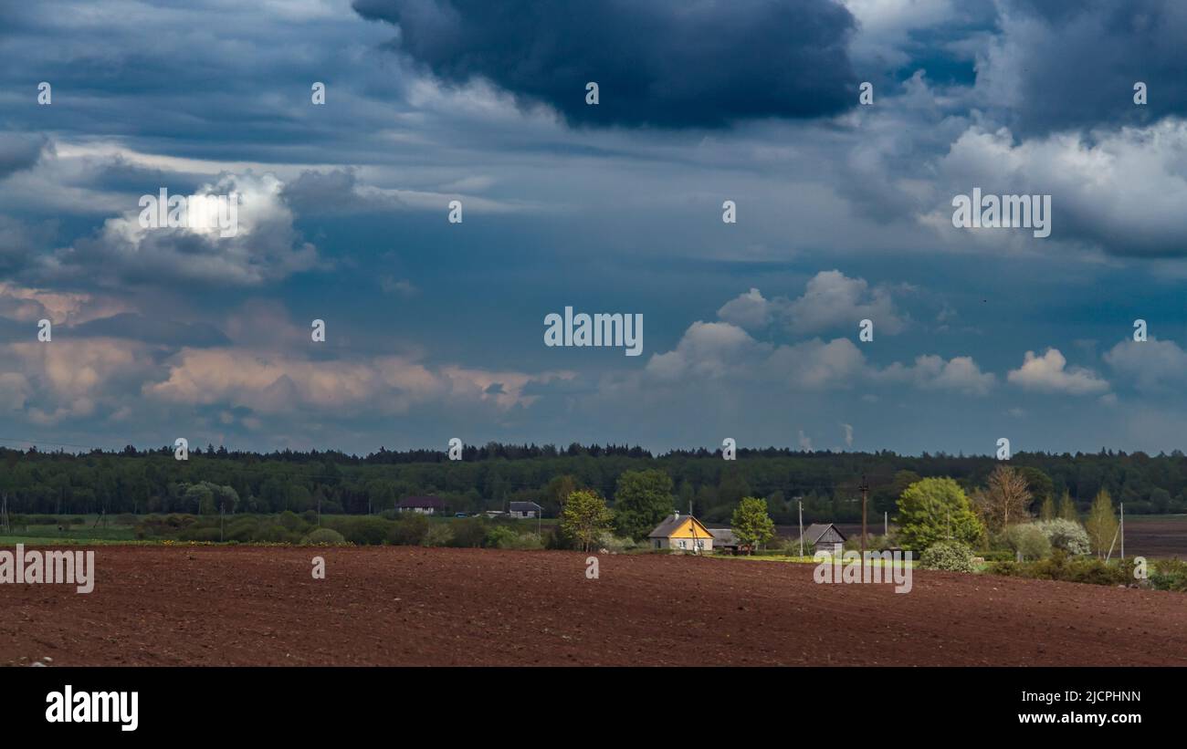 Dramatic sky with dark clouds over a field, dark clouds before rain ...