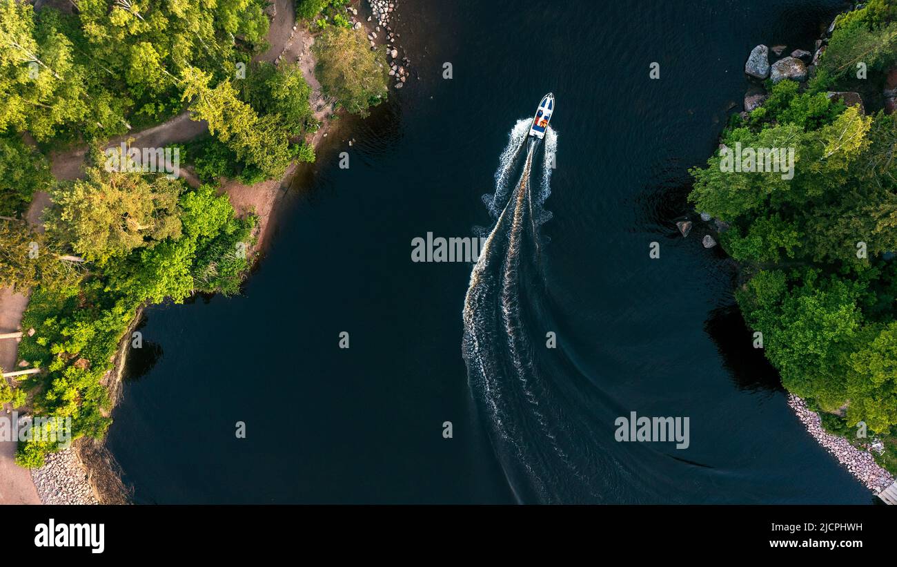 Top view of a white boat sailing in the blue sea. Top view of the boat ...