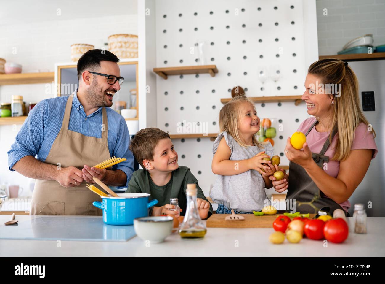 Happy family preparing healthy food together in kitchen. People ...