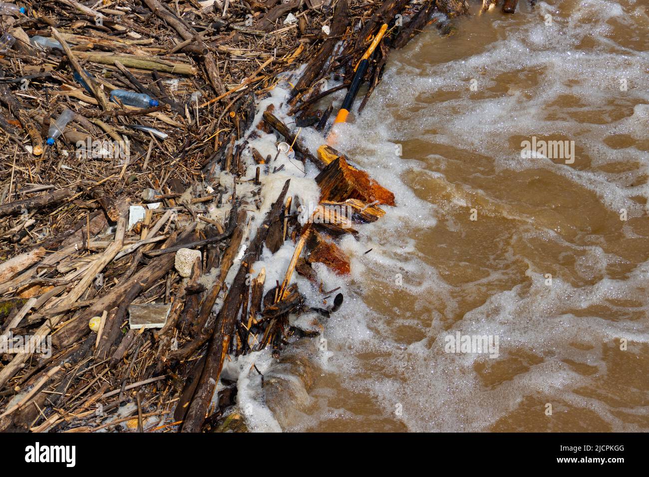 Pile of wood debris and plastic garbage during a flood, environmental ...