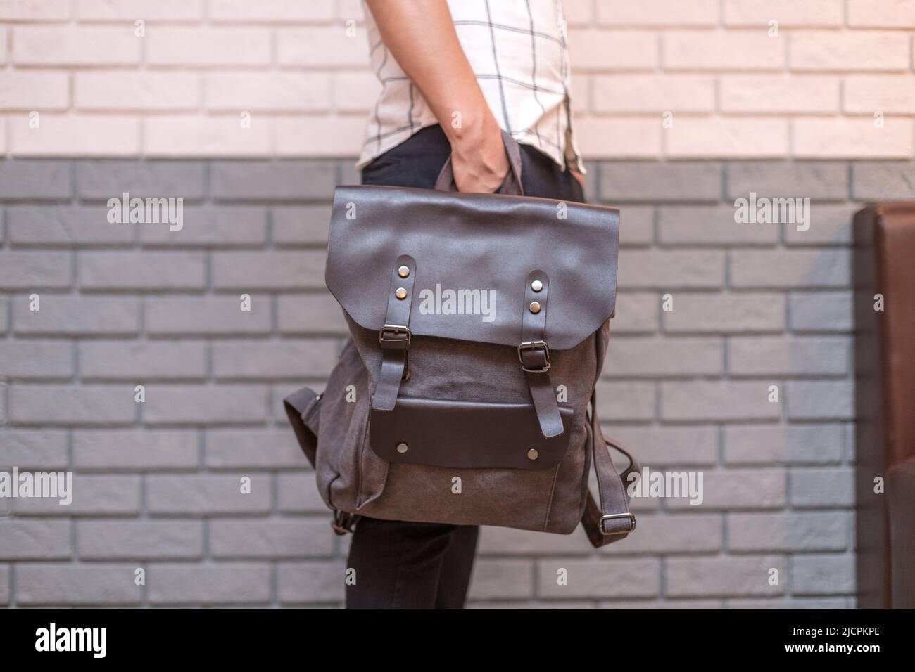 Man holding brown leather bag in the hand. Unisex bags for sale Stock ...