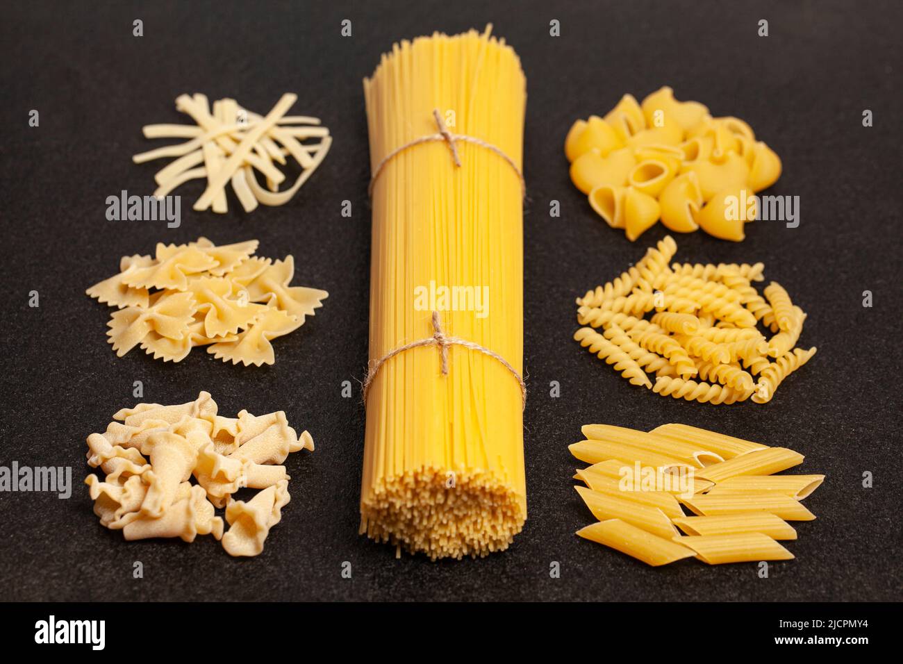 Spaghetti with variety of types and shapes of Italian pasta on black ...