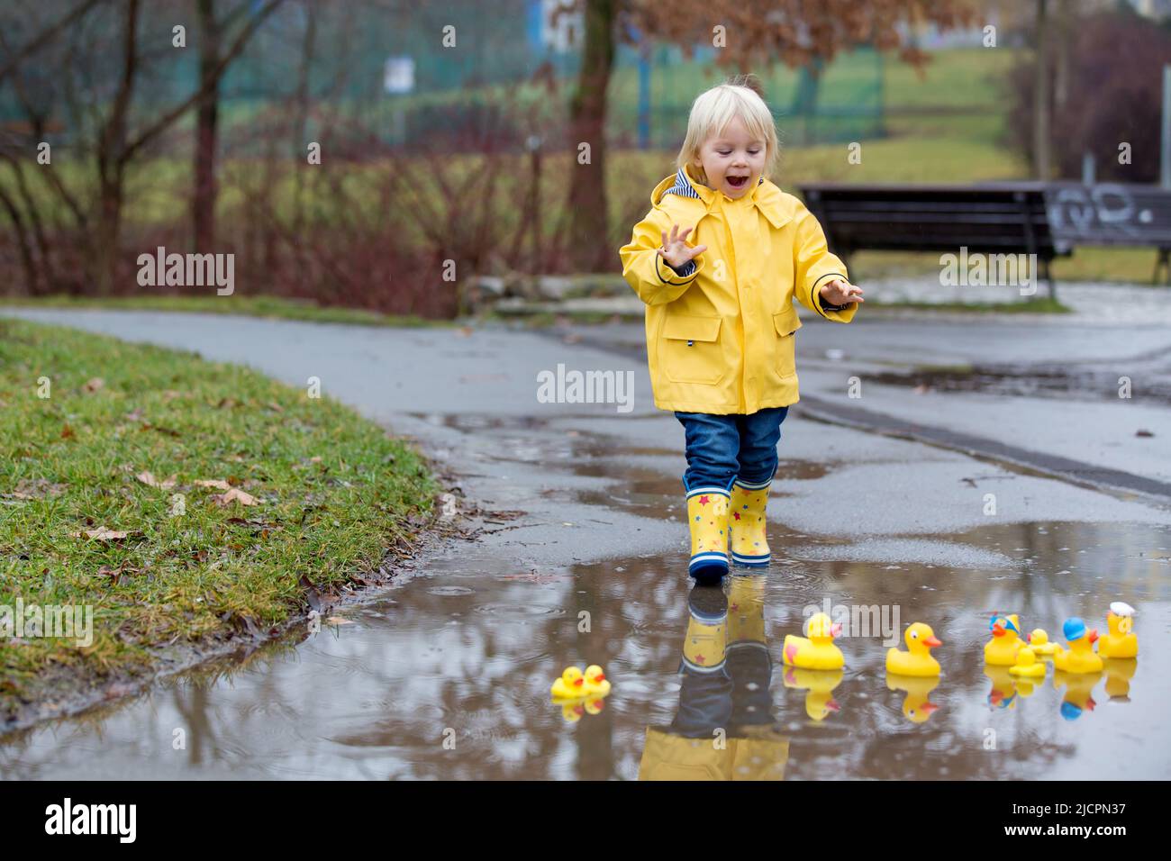Beautiful funny blonde toddler boy with rubber ducks and colorful ...