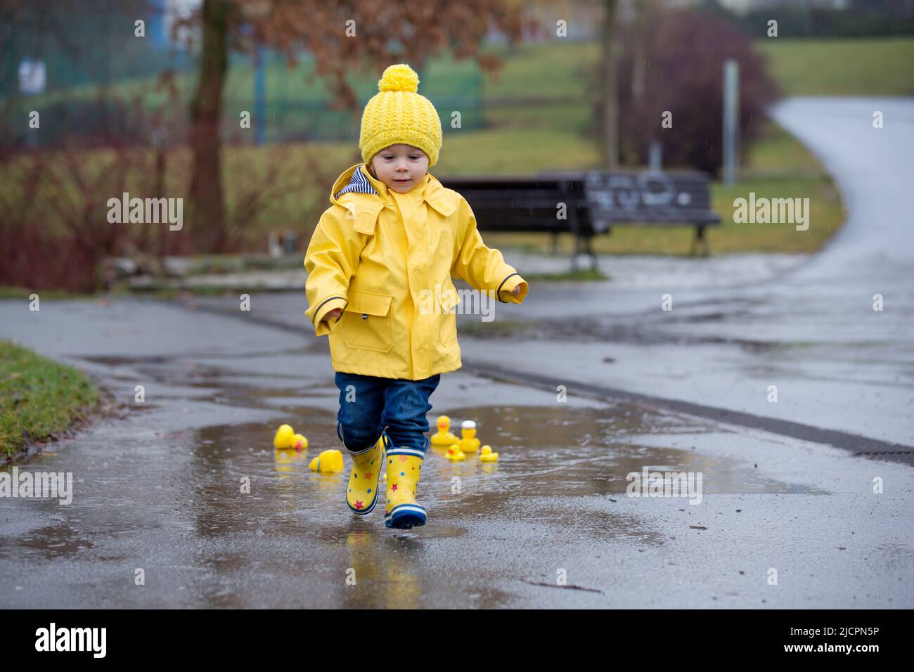 Beautiful funny blonde toddler boy with rubber ducks and colorful ...