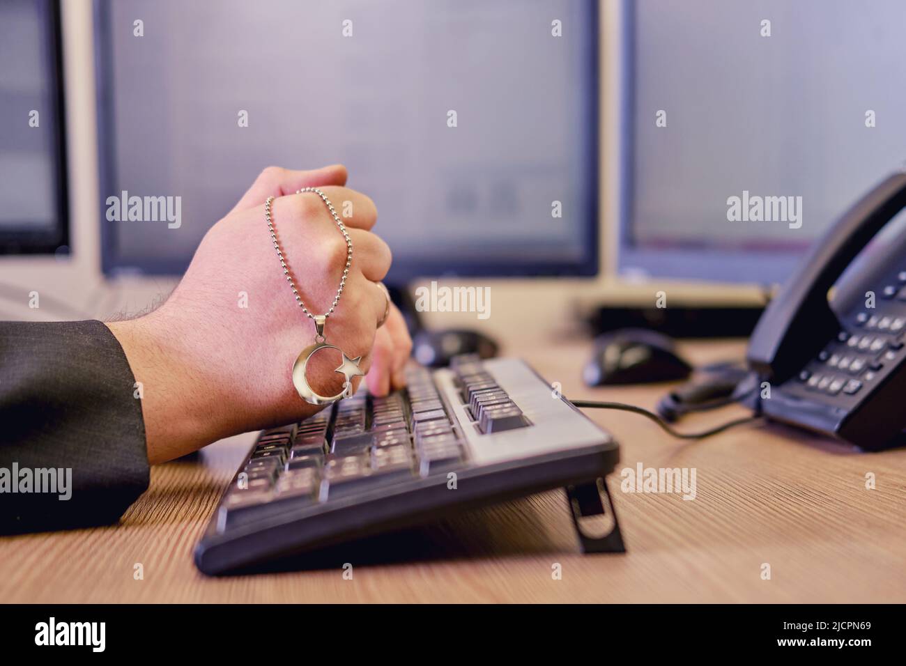 A businessman man with a religious Muslim symbol in his hands is ...