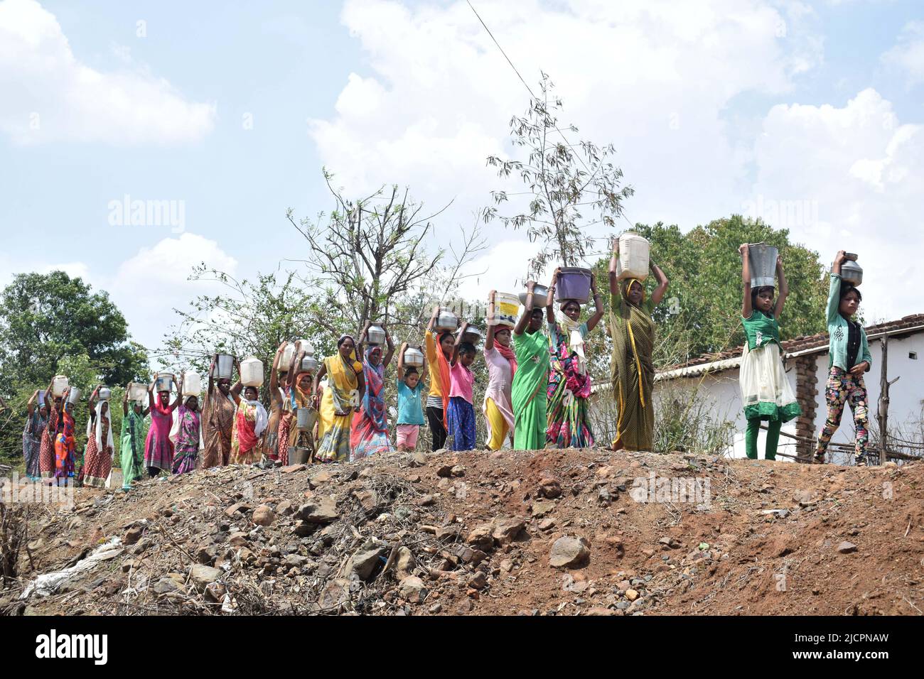 Indian people of an aboriginal 'Kol' community refill drinking water in ...