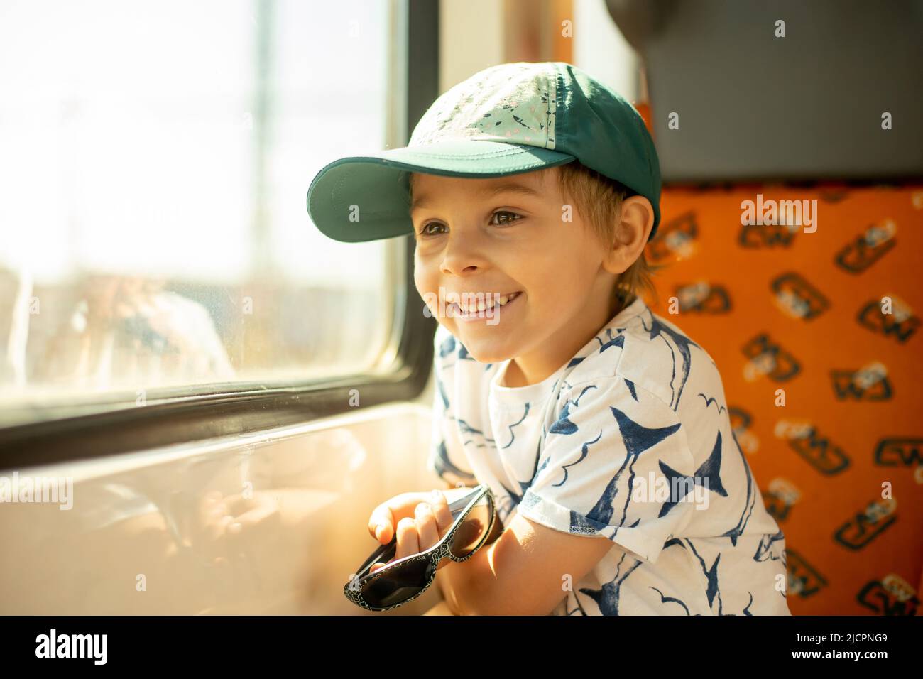 Cute little child, boy, traveling on a train, summertime Stock Photo ...