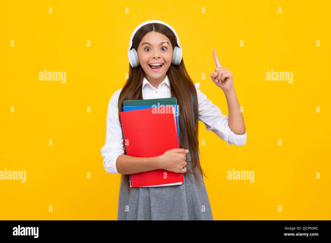 Schoolgirl with copy book posing on isolated background. Literature ...