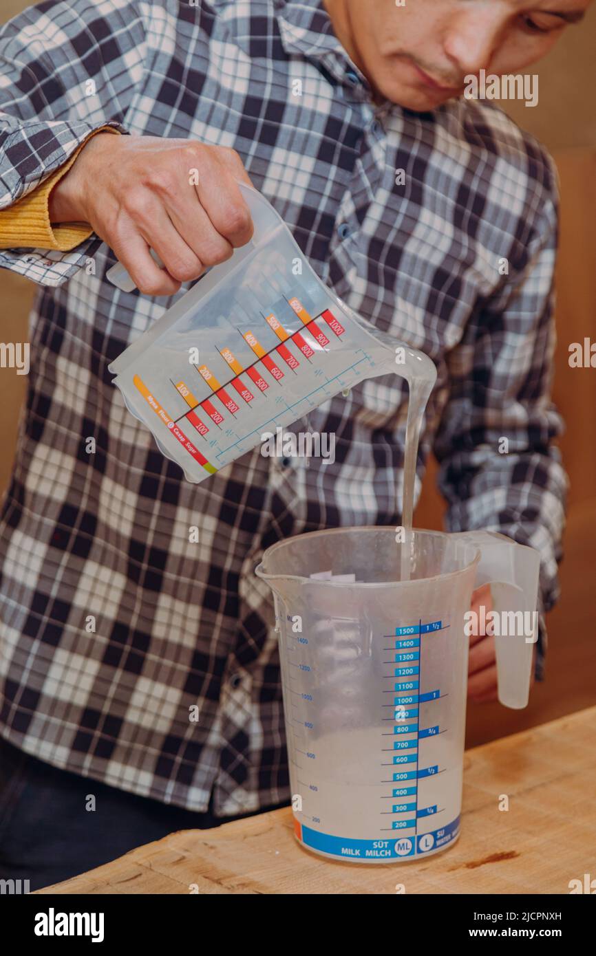 Closeup carpenter pouring liquid epoxy hi-res stock photography and ...