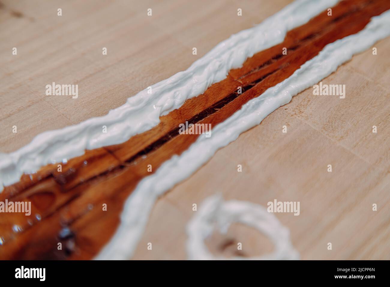Closeup of dried epoxy resin in wood table. Process of making a craft ...