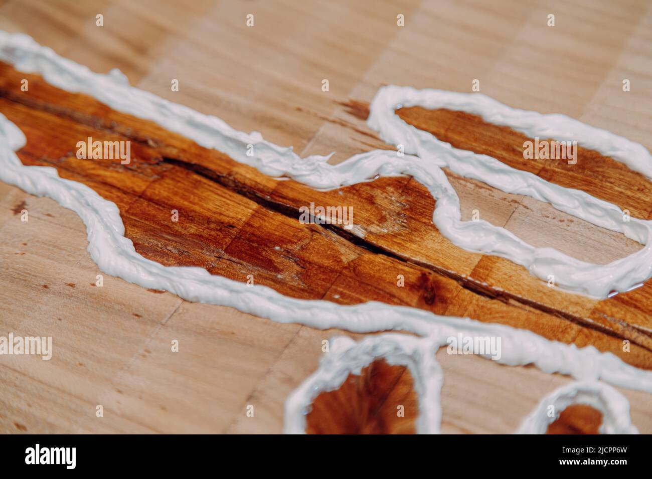 Closeup of dried epoxy resin in wood table. Process of making a craft ...