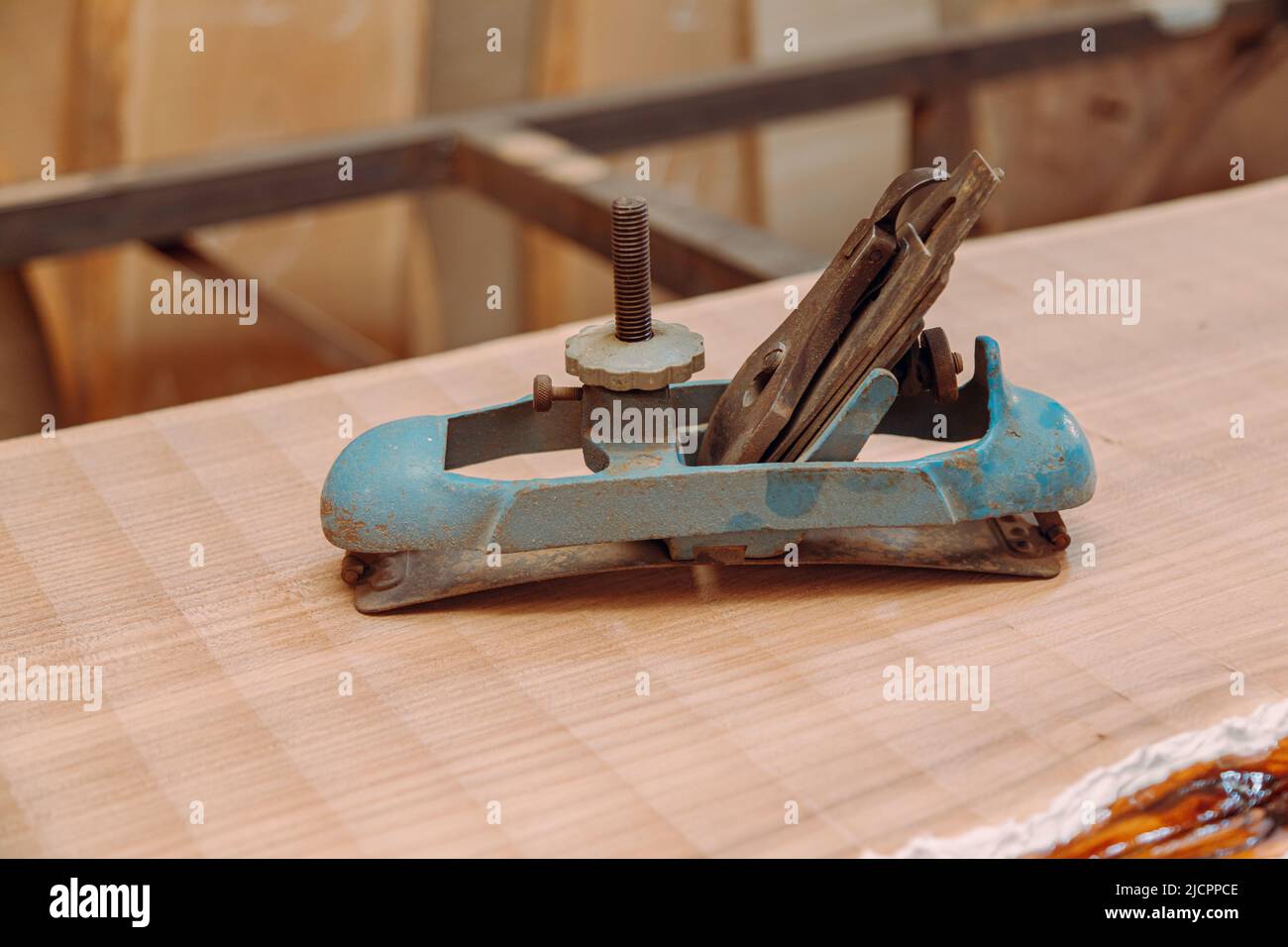 Old metallic jointer plane laying on wood table. Woodworking tools on ...