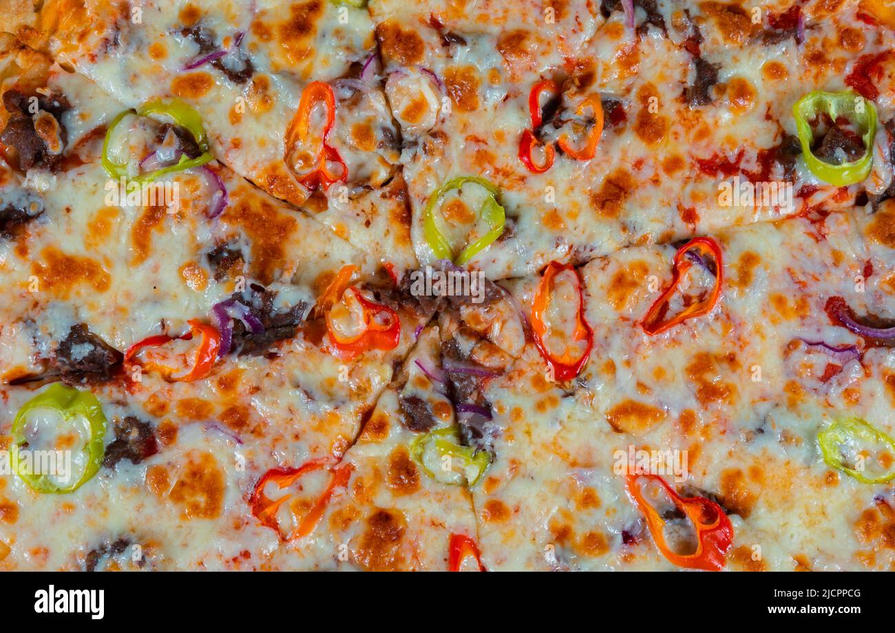 Texture of pizza with meat and vegetables on a black background Stock ...