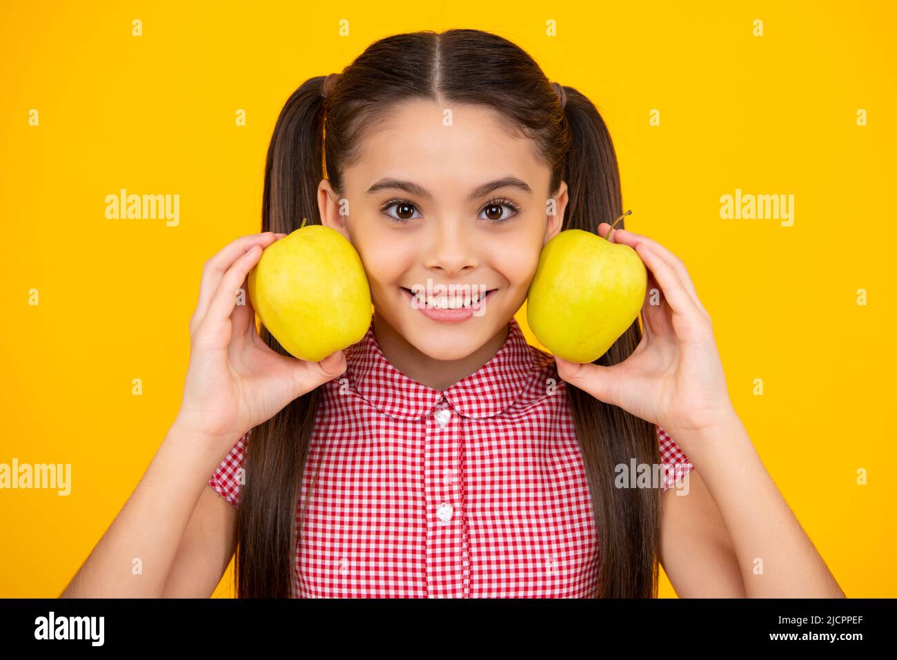 Teenager child with apple on yellow isolated background. apples are ...