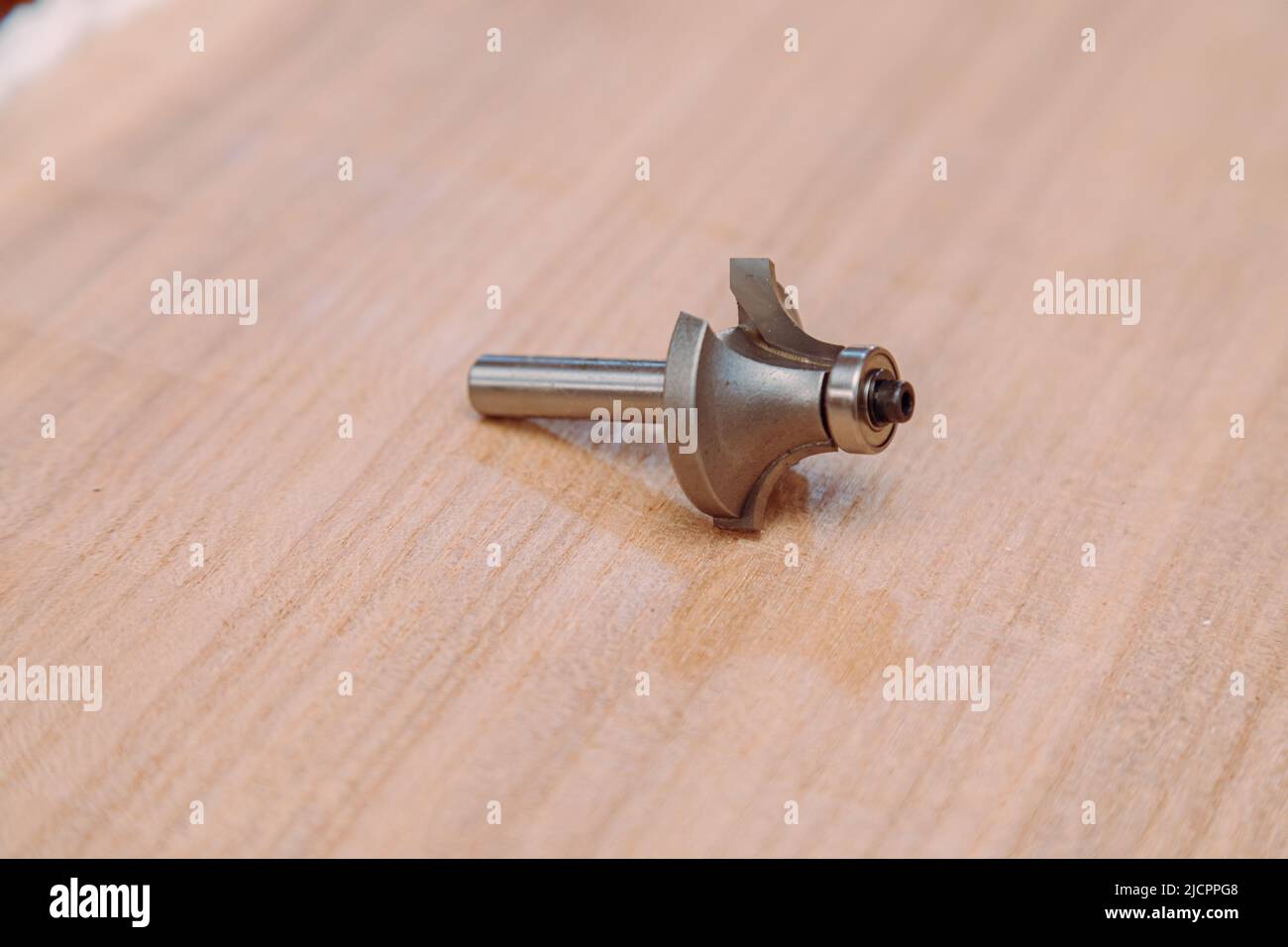 Steel router bit for milling cutter on a wooden table Stock Photo - Alamy