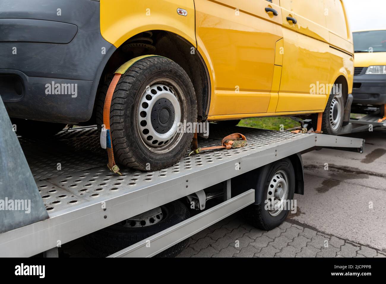 White small cargo truck car carrier loaded with two yellow van minibus ...