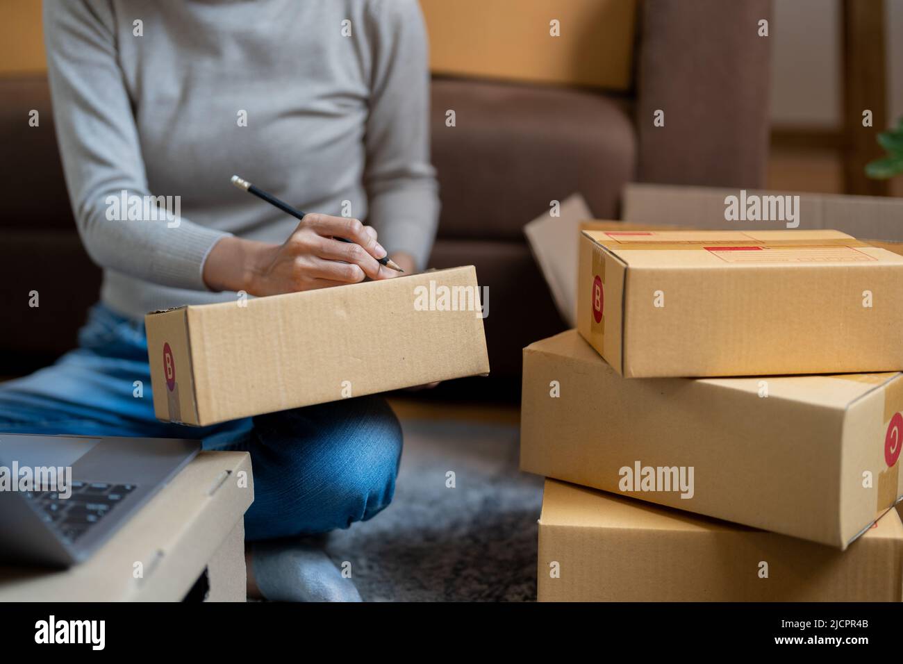 Shipping shopping online, young start up small business owner writing ...