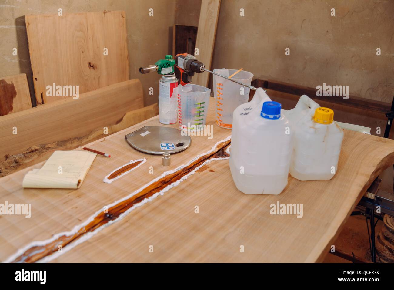 Wooden table with tools for preparing epoxy resin Stock Photo - Alamy