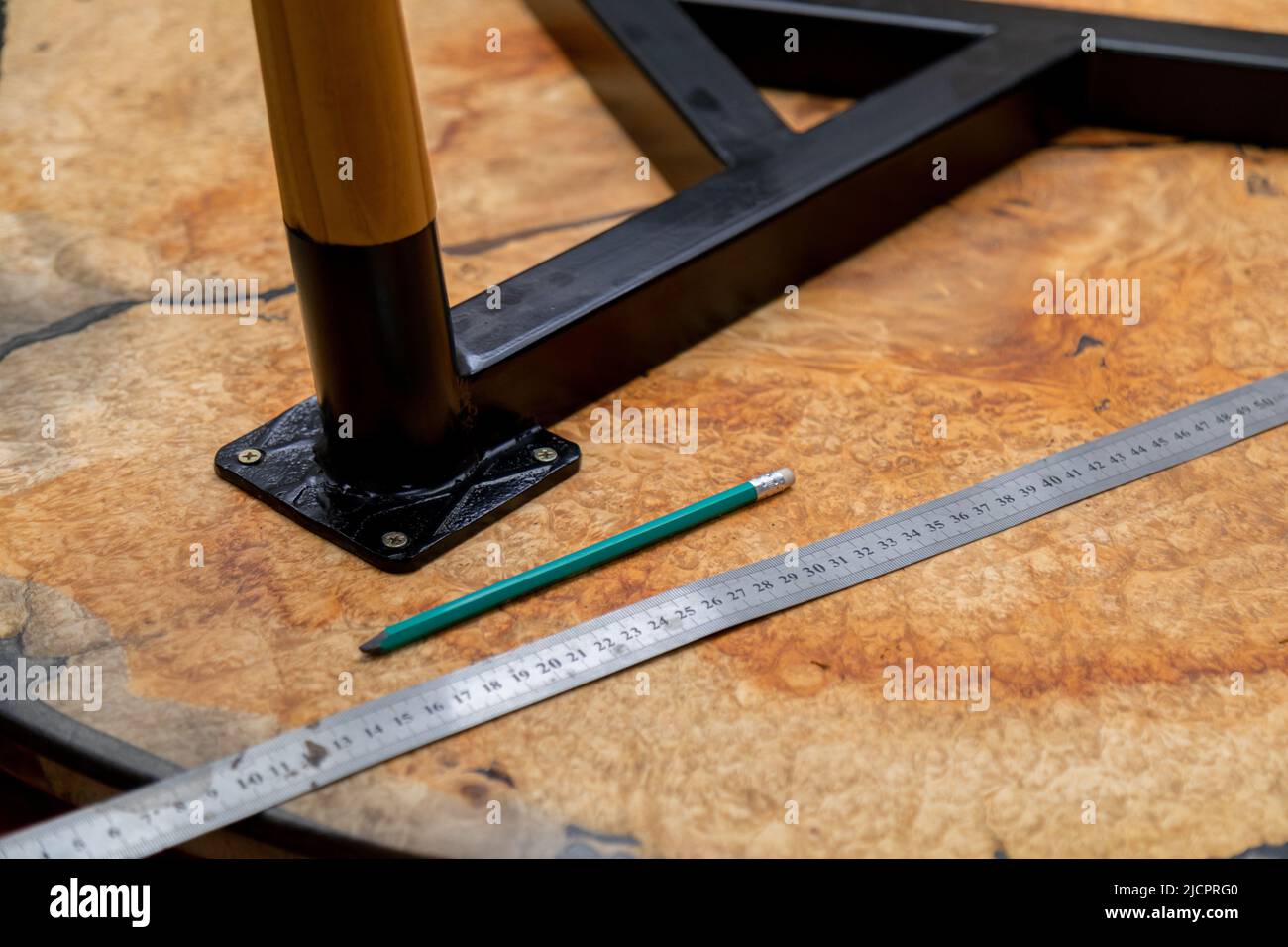 Closeup of iron ruler with pen on a wood table Stock Photo - Alamy
