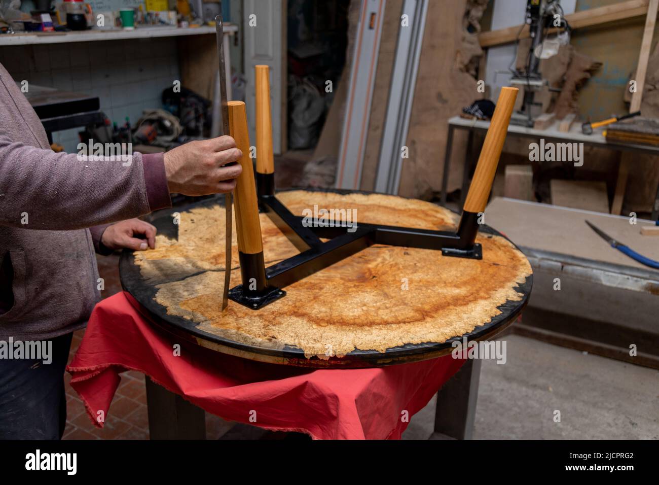 Person measuring the distance of a table leg with an iron ruler Stock ...