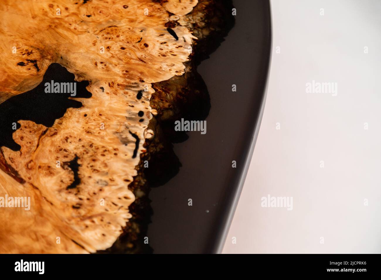 Closeup of epoxy resin round table edge on white background Stock Photo ...