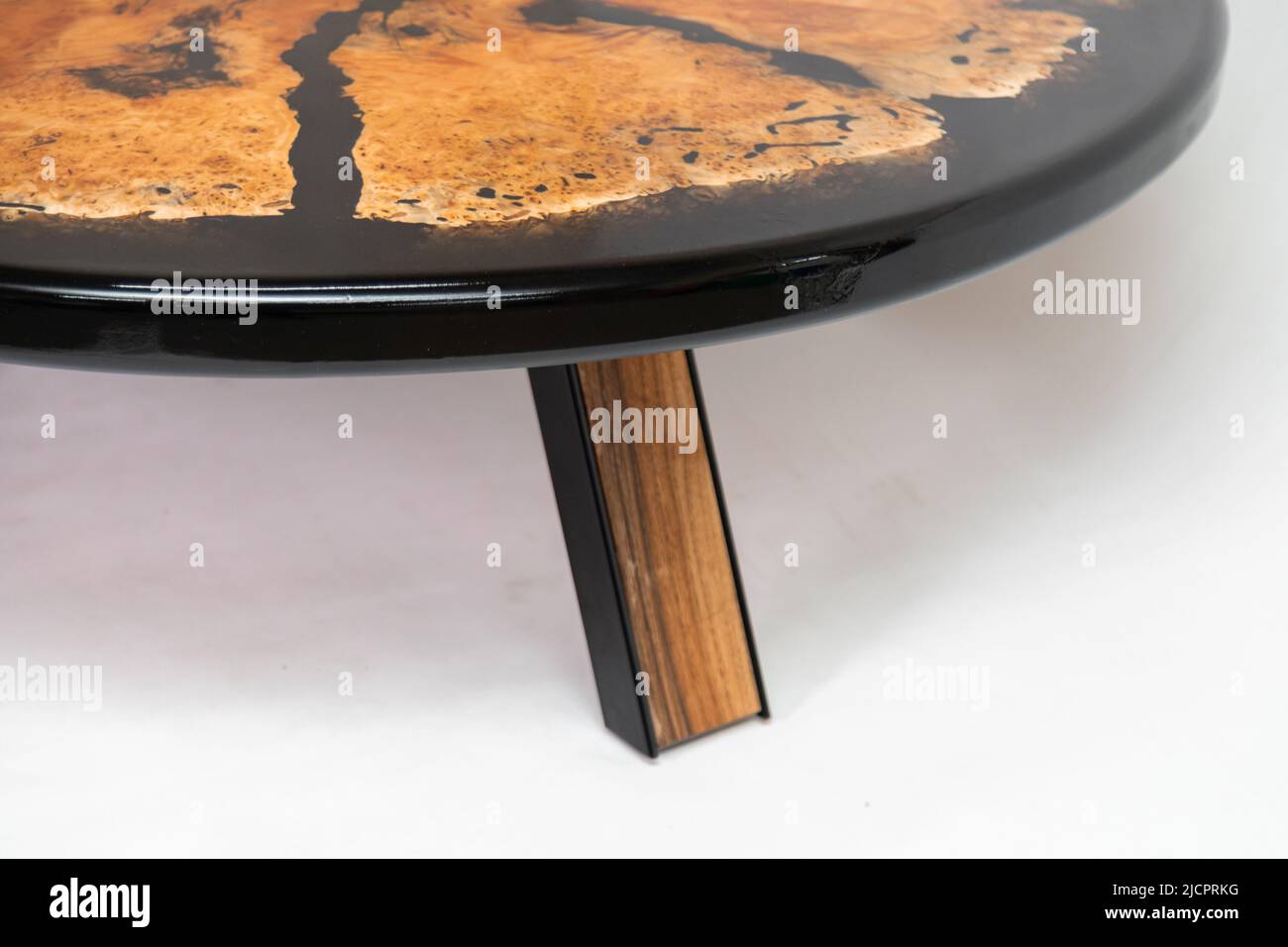 Closeup of epoxy resin round table edge on white background Stock Photo ...