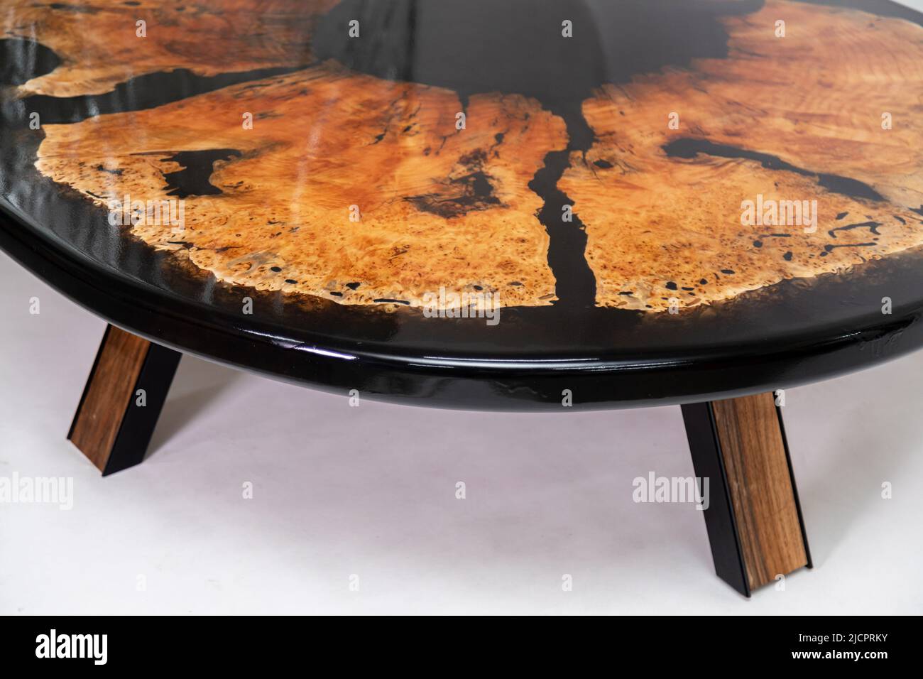 Closeup of epoxy resin round table edge on white background Stock Photo ...