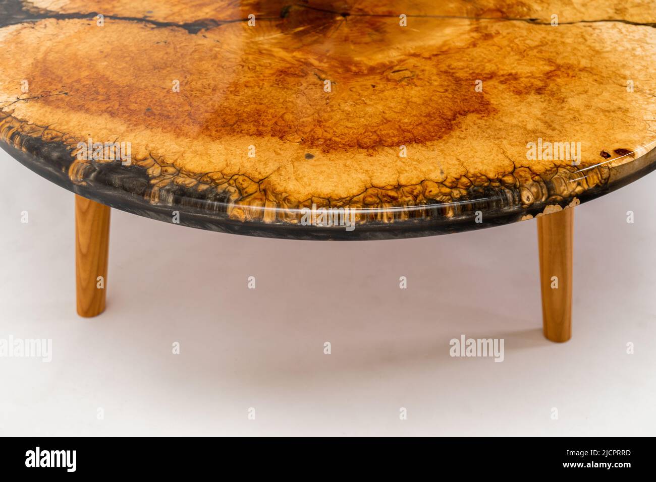Closeup of epoxy resin round table edge on white background Stock Photo ...