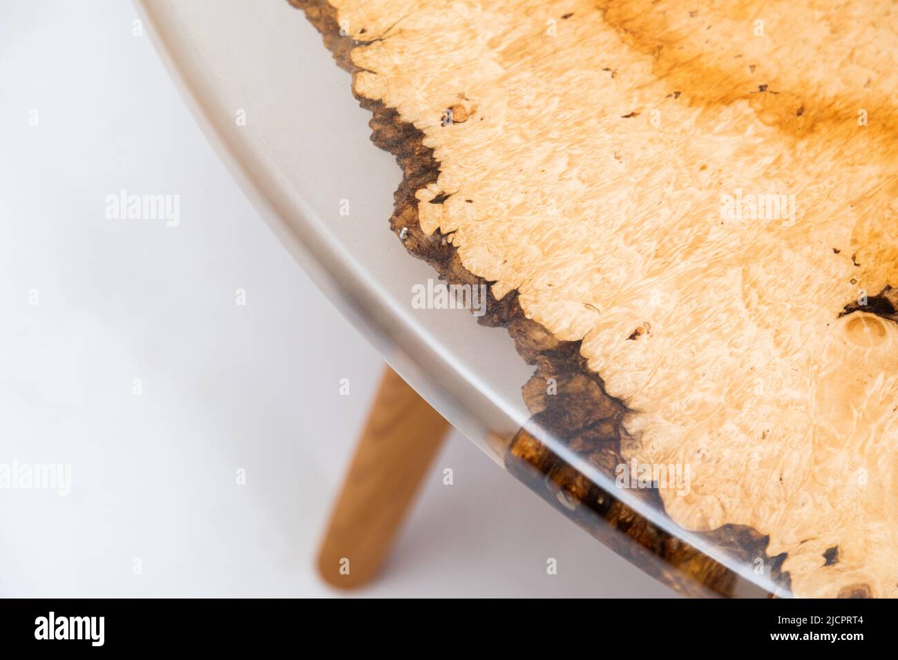 Closeup of epoxy resin round table edge on white background Stock Photo ...