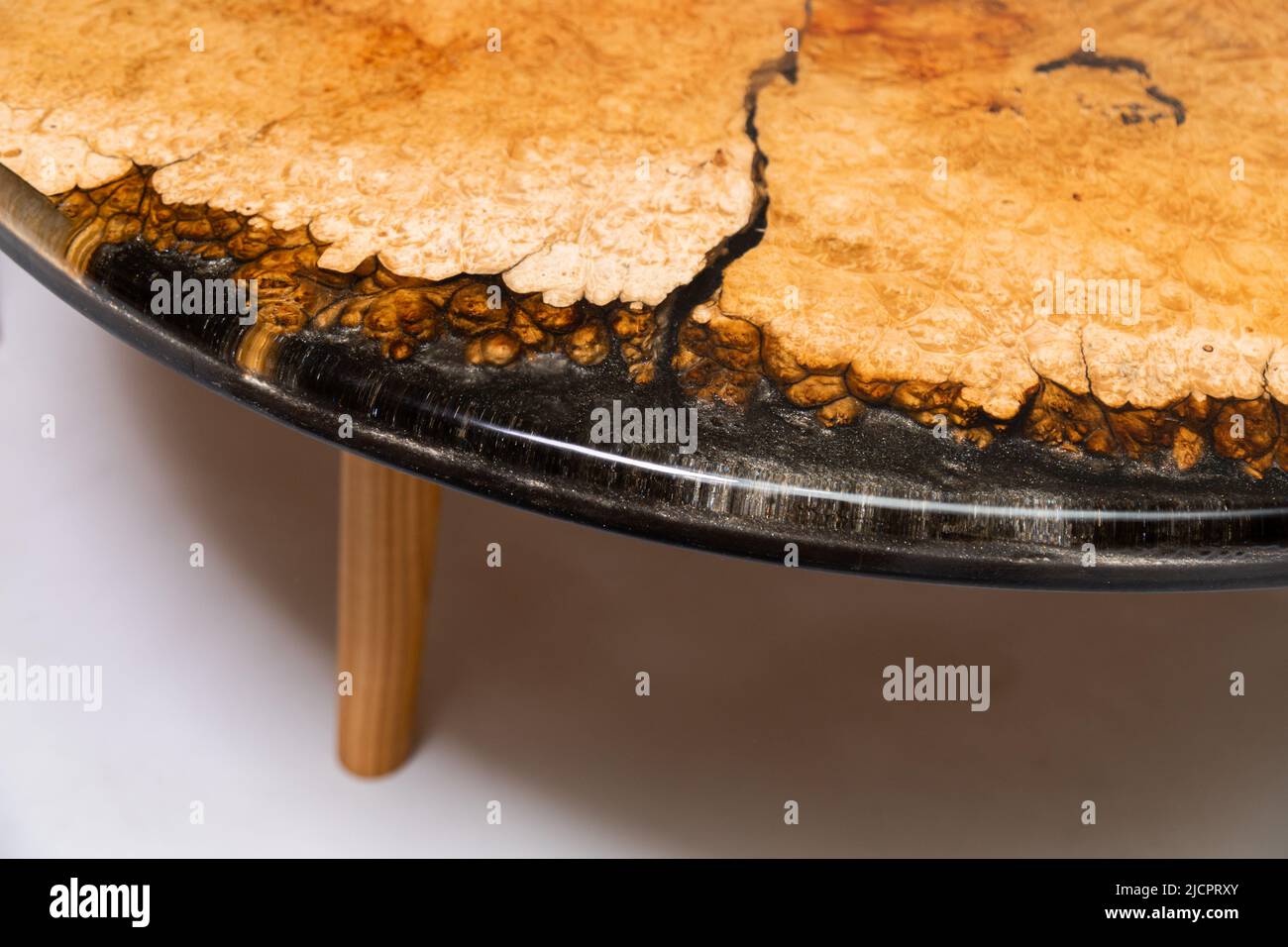 Closeup of epoxy resin round table edge on white background Stock Photo ...