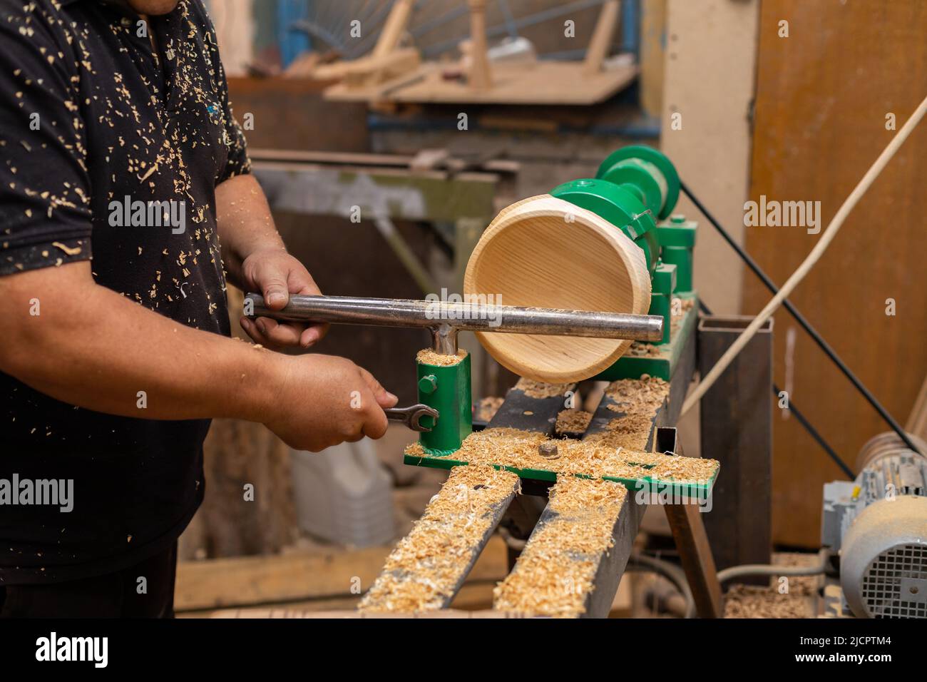Carpenter preparing machine for turning wood on a lathe Stock Photo - Alamy