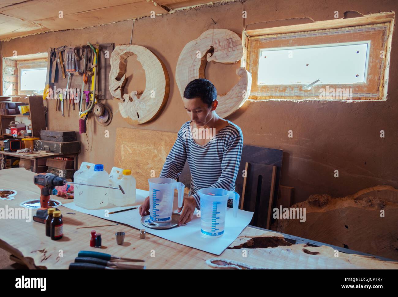 Carpenter preparing tools for woodworking and carpentry production ...