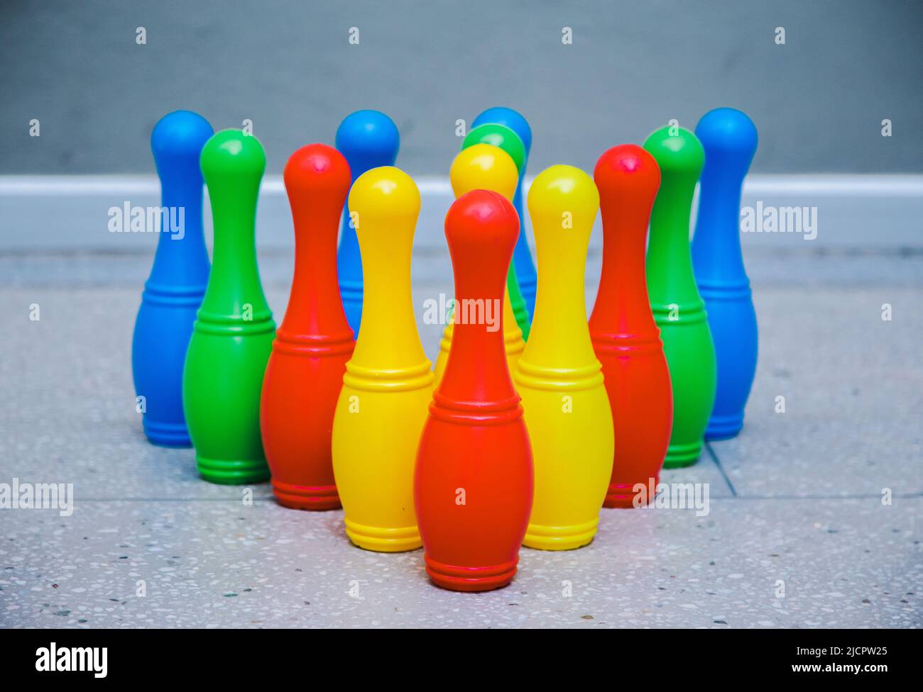 Set of colorful plastic toy bowling pins standing on the floor Stock ...